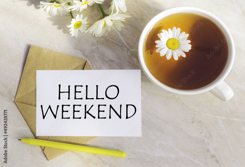 HELLO WEEKEND, cup of chamomile tea with chamomile flowers. Healthy ...