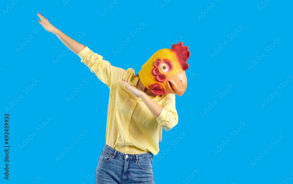 Funny girl disguised as hen or chicken dancing in the studio. Portrait ...