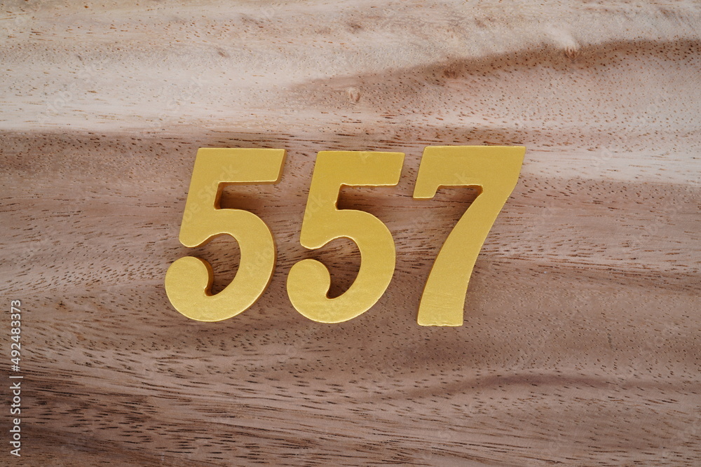 Golden Arabic numerals on a real brown and white wooden floor number ...