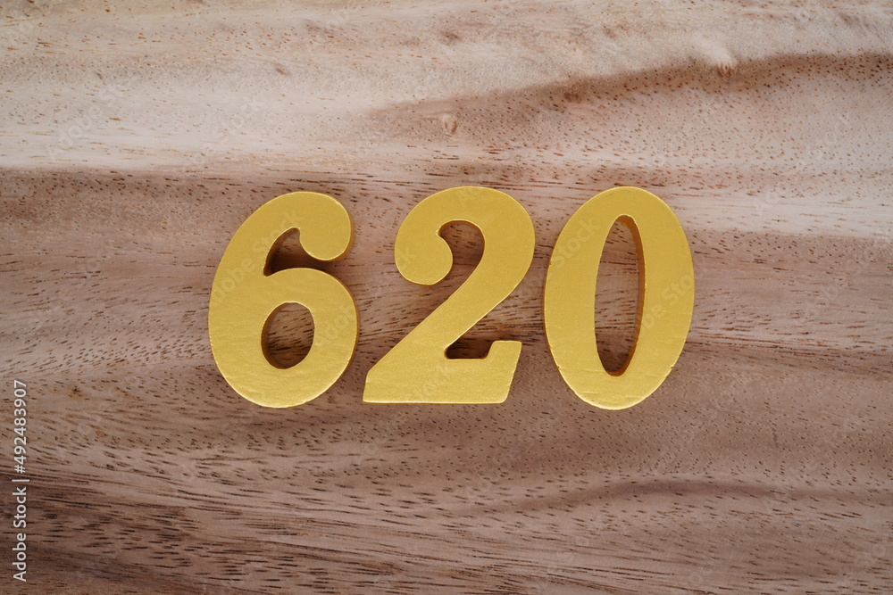 Golden Arabic numerals on a real brown and white wooden floor number ...