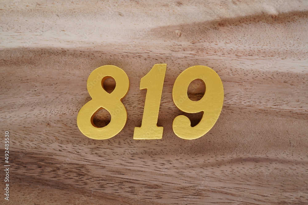 Golden Arabic numerals on a real brown and white wooden floor number ...