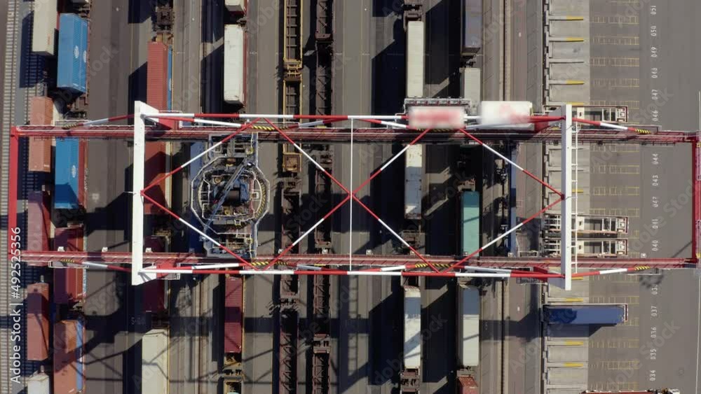 Flying above industrial railroad station with cargo trains and freight ...