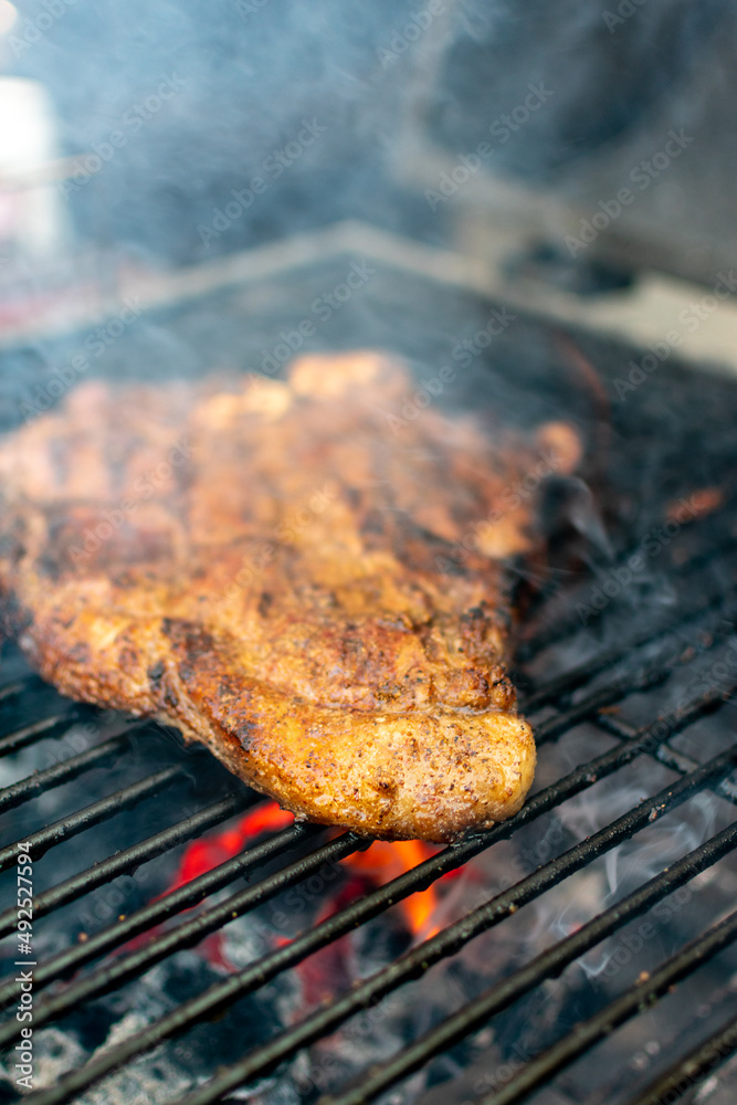 corte de res T- bone. T bone corte en el asador corte al carbón manos ...