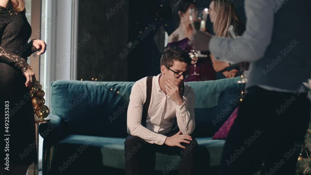 Portrait of upset man in decorated house at a party. Sad and unhappy ...