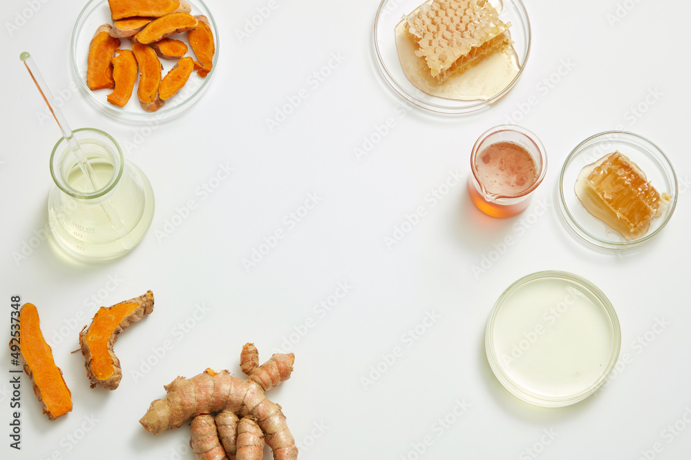 Honey and turmeric decorated with transparent podium and beaker test ...