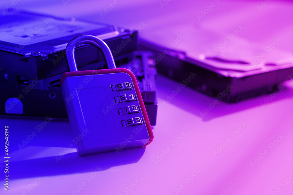 Encrypted hard disk. Padlock with cipher on an opened hard disk. Data ...