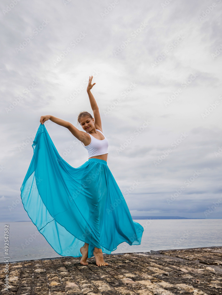 Caucasian woman practicing ballet pose. Young ballet dancer wearing ...