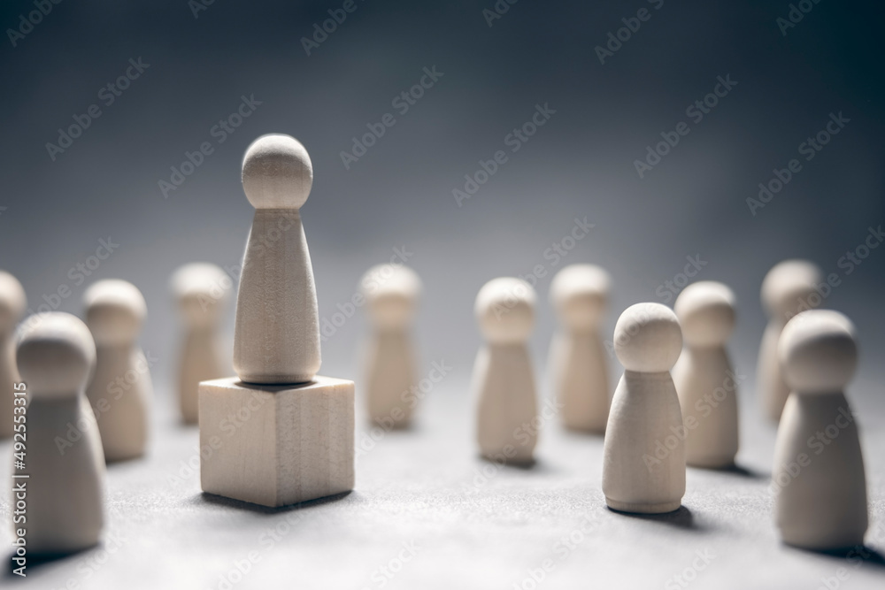 Leadership wooden business team with one person standing out from the ...
