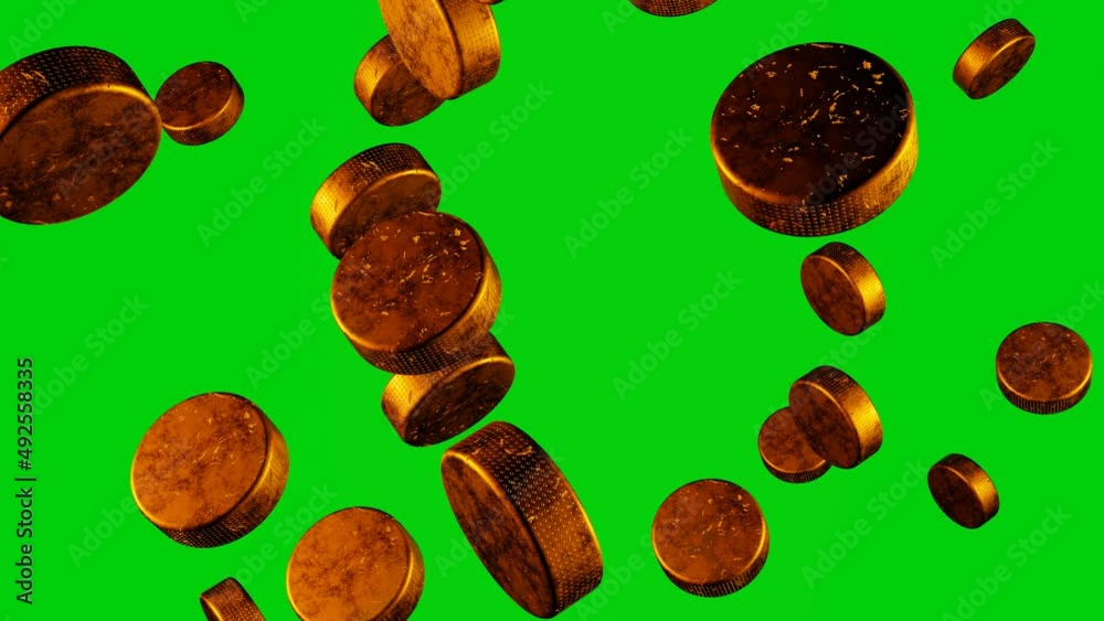 Many golden hockey pucks flying to camera on chromakey background ...
