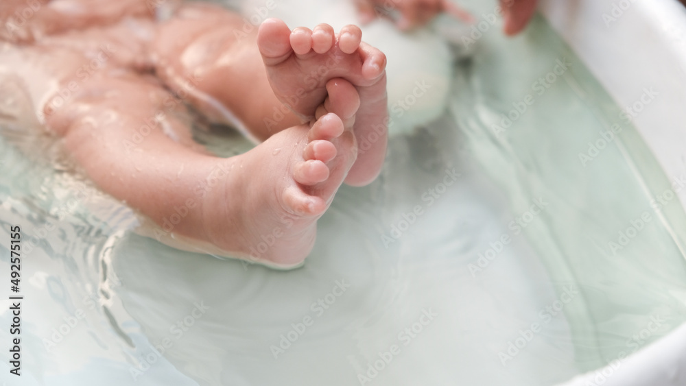 Baby feet in the bathroom with white water close-up. happy kids, 3 ...