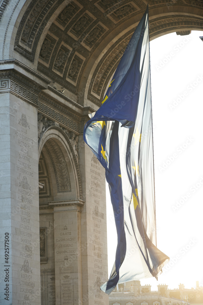 Flag of the European Union winding under the landmark Arch of Triumph ...