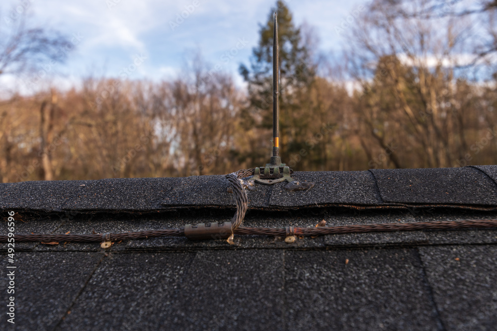 Close up of lighting rod mounted on a residential roof to ground the ...