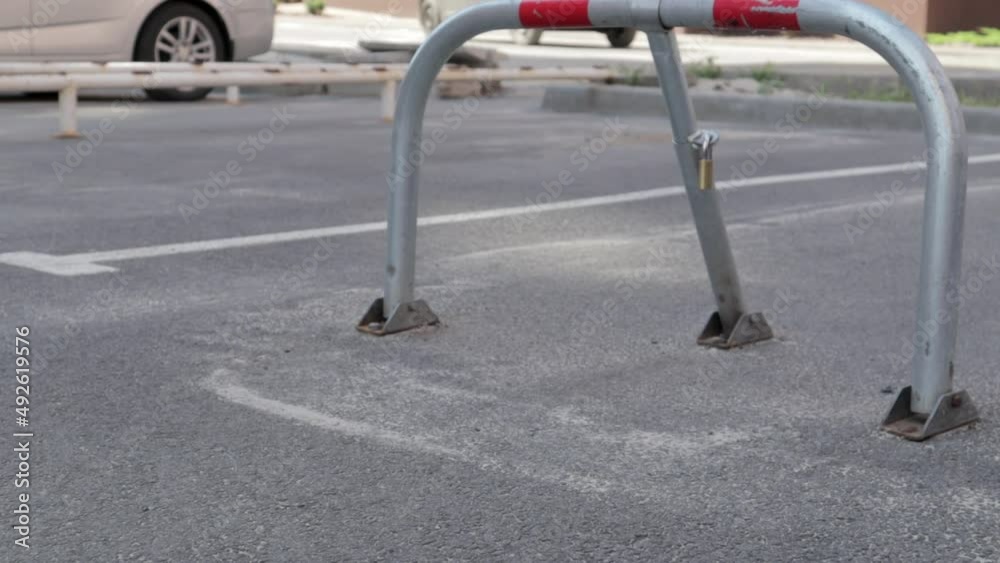 One gray parking lock. Close-up video. Reserved car parking space ...