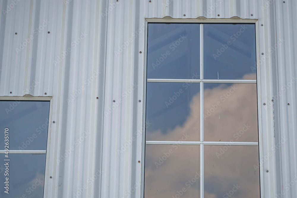 White metal wall tiles, vertical stripes pattern and grids glass ...