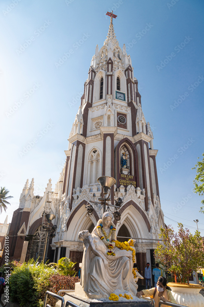 People walking near beautiful church of 17th century, catholic St. Mary ...