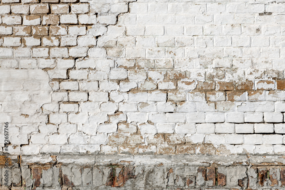 Cracked damaged old white brick wall as background and urban texture ...