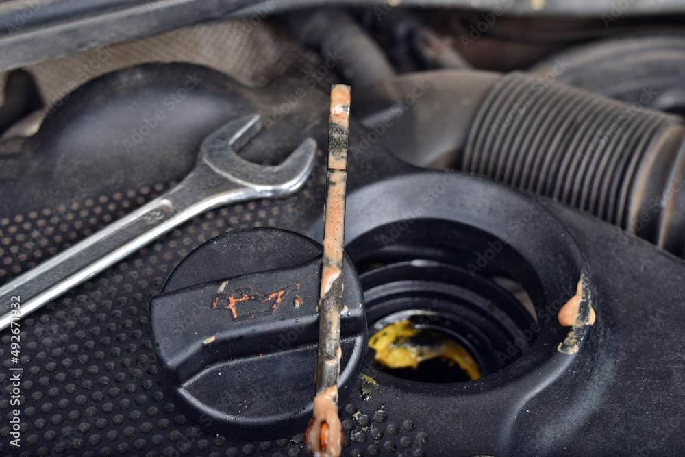 The thick, greasy yellow motor oil under oil cap as signs and symptom ...