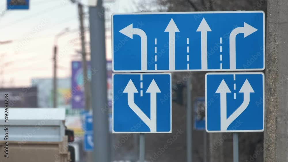 Traffic sign pointing multiple road lanes direction on city street ...
