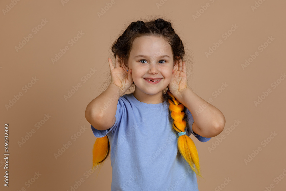 Curious small Caucasian girl with kanekalon braids smiling with missing ...