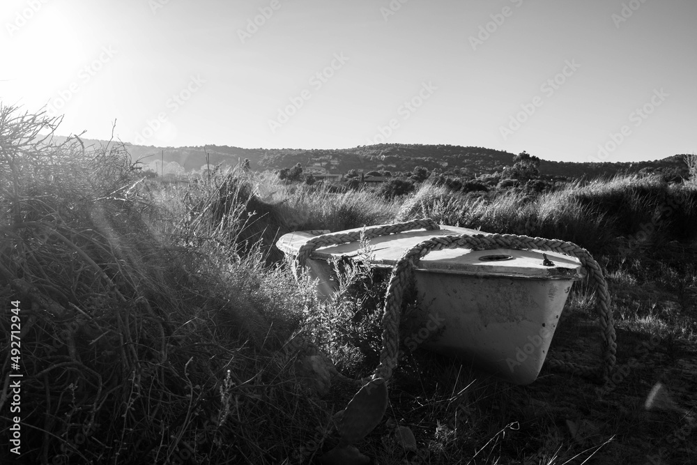 Old broken abandoned boat in the bushes. Old vintage fishing boat ...