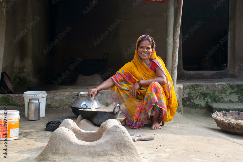 Rural Indian Woman cooking food in the Kitchen using firewood stove ...