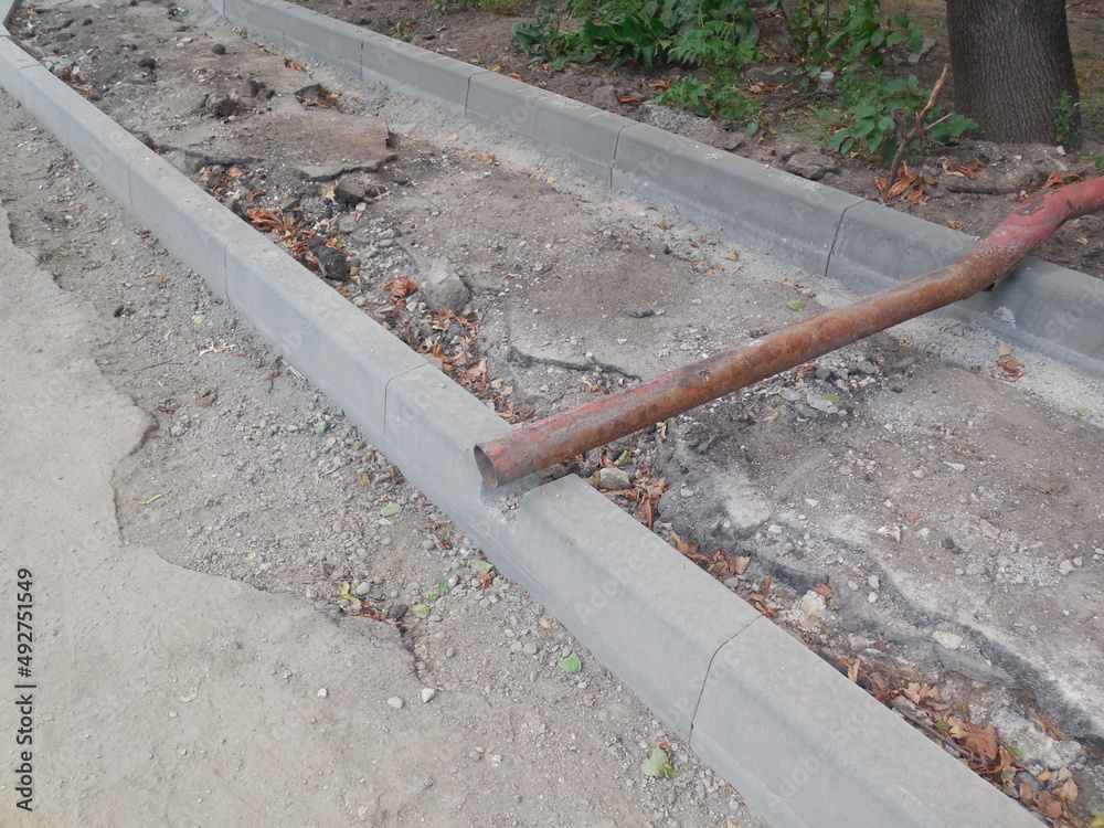 Repair and construction of road works. Installation of a concrete curb ...