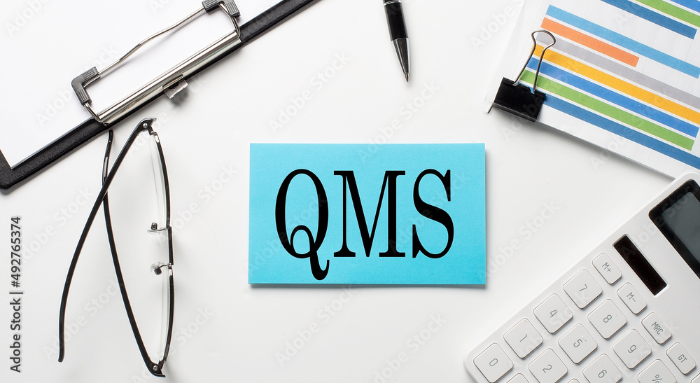 Stickers with chart,calculator and paper with text QMS on white ...