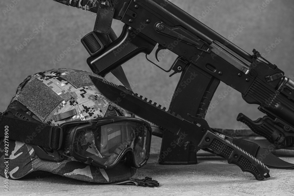 A military helmet, a machine gun and a knife. War fighting special ...