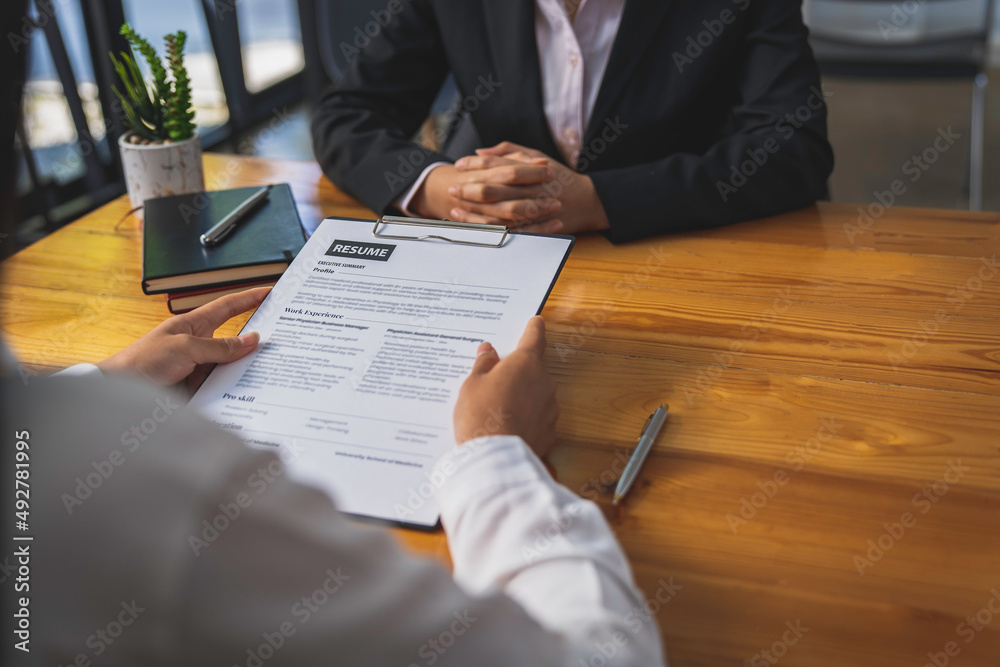 Employer or recruiter holding reading a resume during about colloquy ...