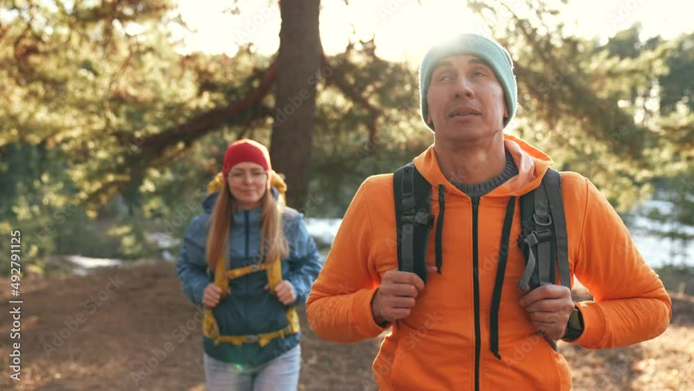 Teamwork. a group of hikers tourists walk through the forest unity with ...