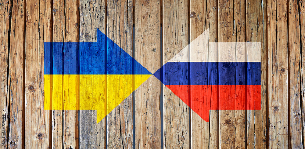 Ukranian rrow vs Russian arrow with flags painting on wooden fence ...