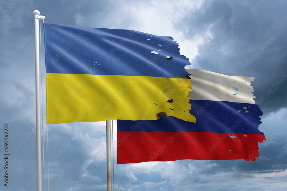 Russian and Ukrainian flag on a flagpole waving in the wind on a cloudy ...