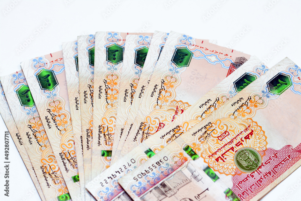 Selective focus of a pile of 100 AED one hundred Dirhams banknote ...