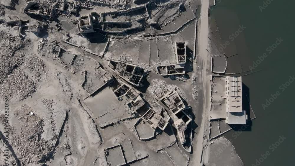 Aerial top-down descending over ruins of Aceredo submerged village in ...
