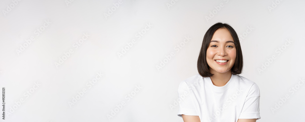 Beautiful korean girl smiling, white teeth, looking lovely at camera ...