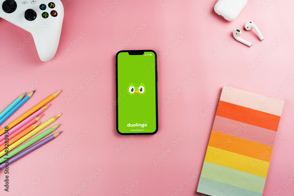 Duolingo language-learning app on the smartphone screen. Pink ...