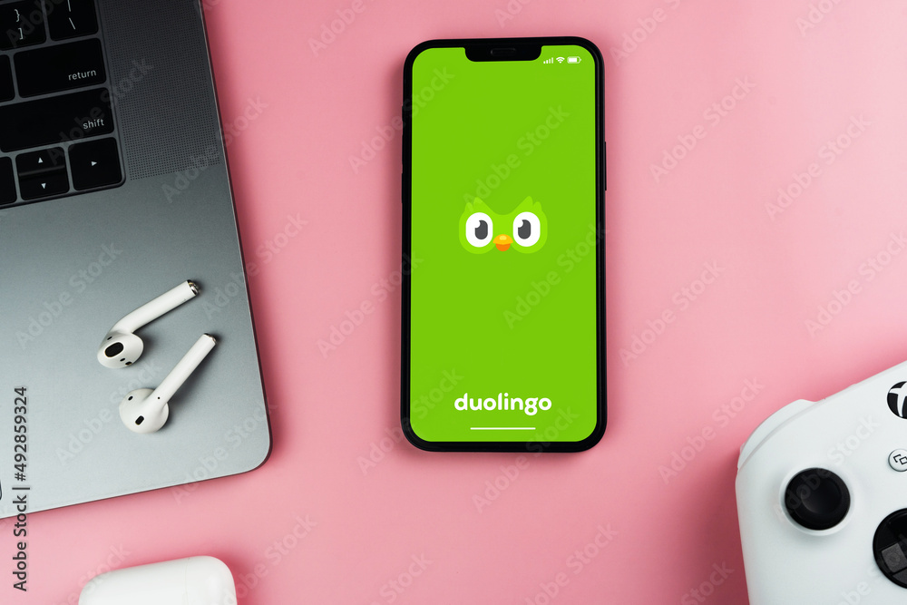 Duolingo language-learning app on the smartphone screen. Pink ...