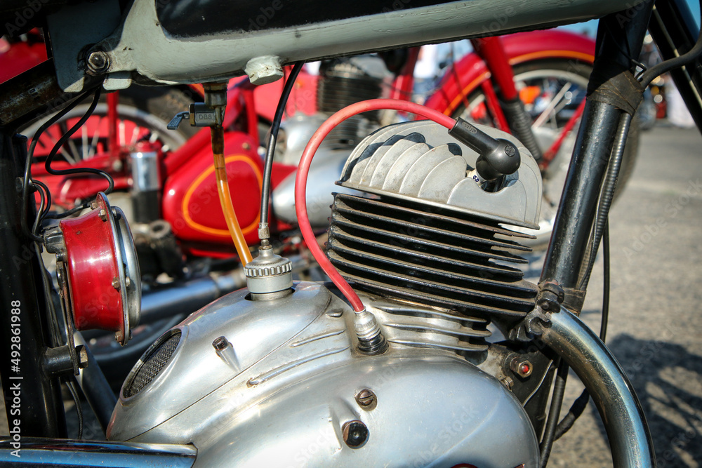 The detail of the polished old motorbike with the two stroke engine ...