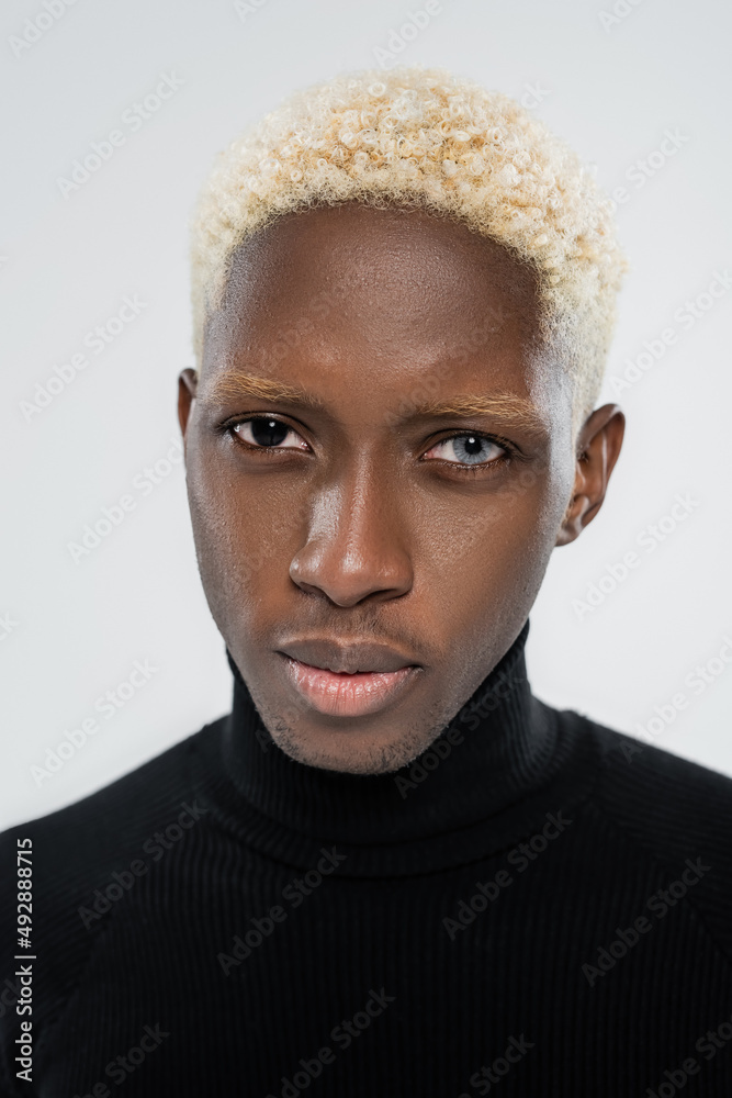 portrait of blonde african american man with heterochromia isolated on ...