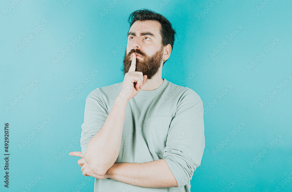 Handsome hipster bearded thinking something and trying to find a ...
