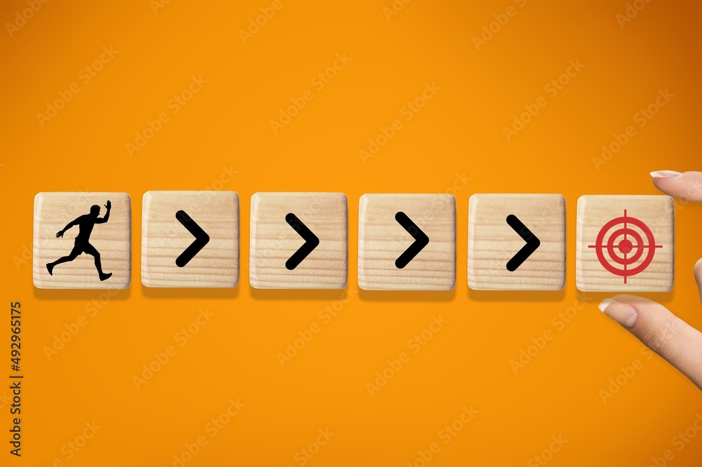 Cube with a human icon running towards the target. Symbol of resolute ...