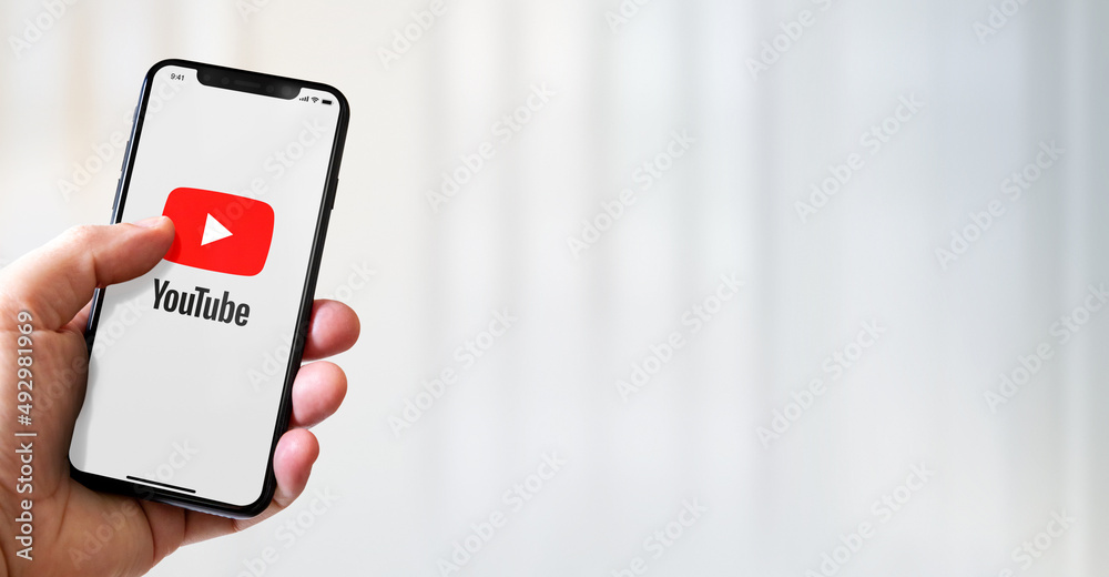 Hand holding iphone smartphone with YouTube logo, Paris, France Stock ...
