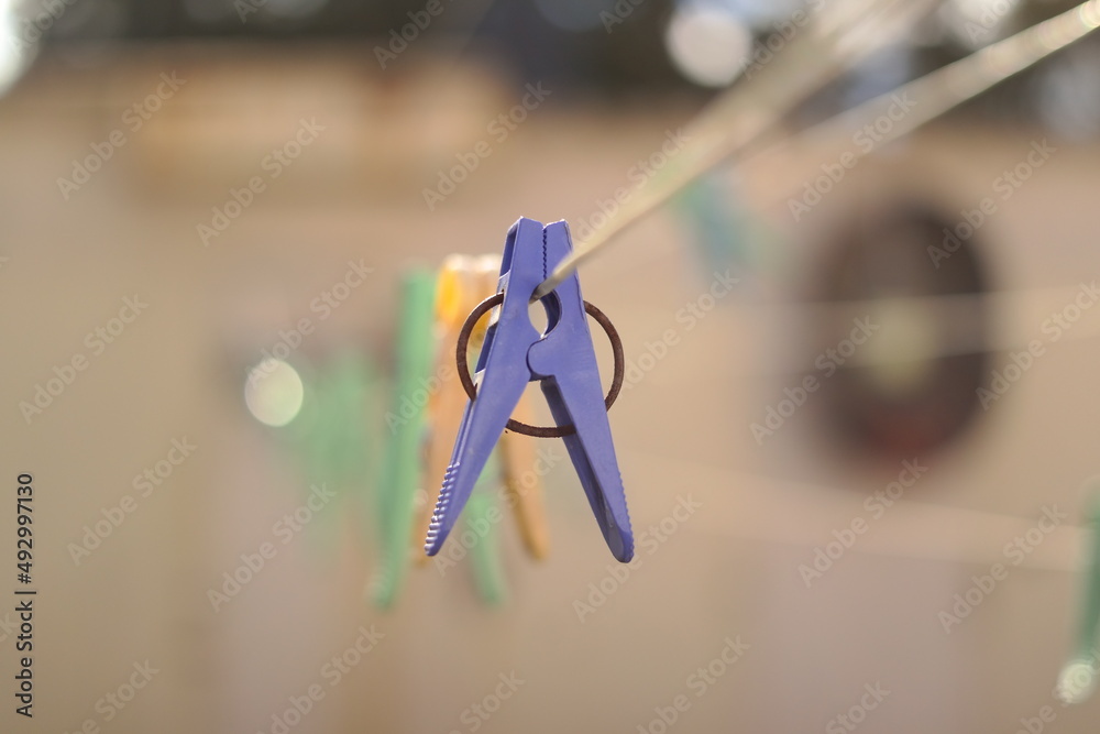 old pegs on a rope. One old retro clothespin wooden on a linen rope ...