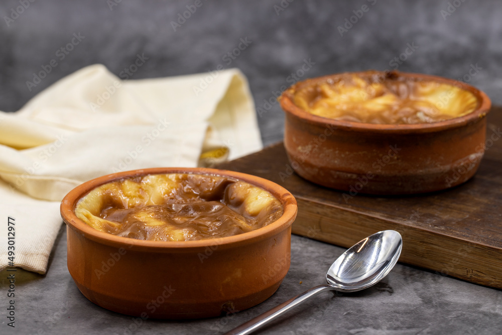 Casserole rice pudding on a dark background. A delicious dessert made ...