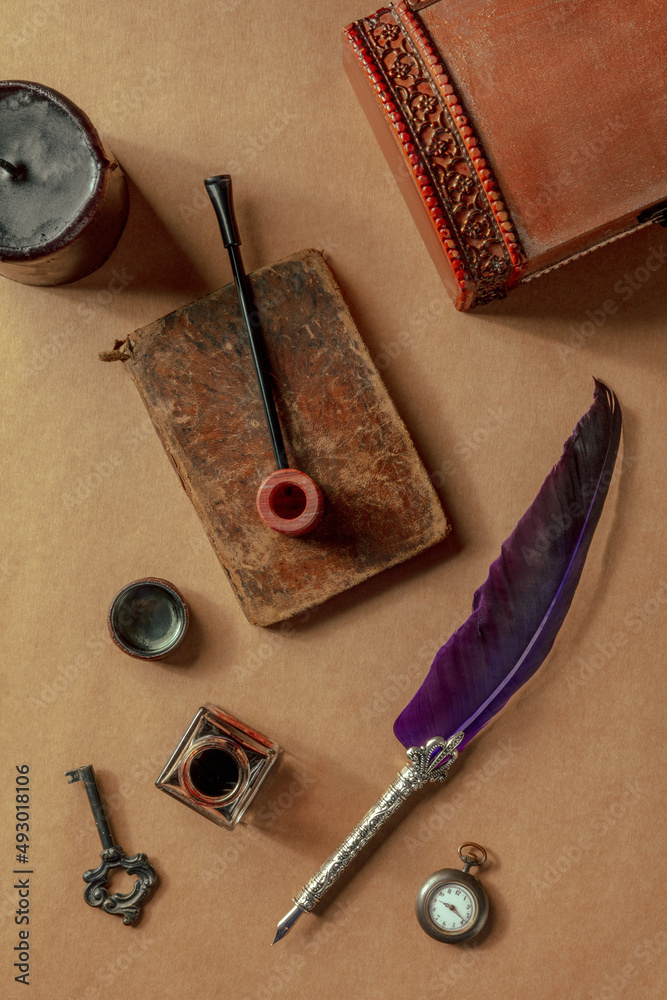 Vintage pipe, notebook, a quill pen, and a retro watch. Private ...