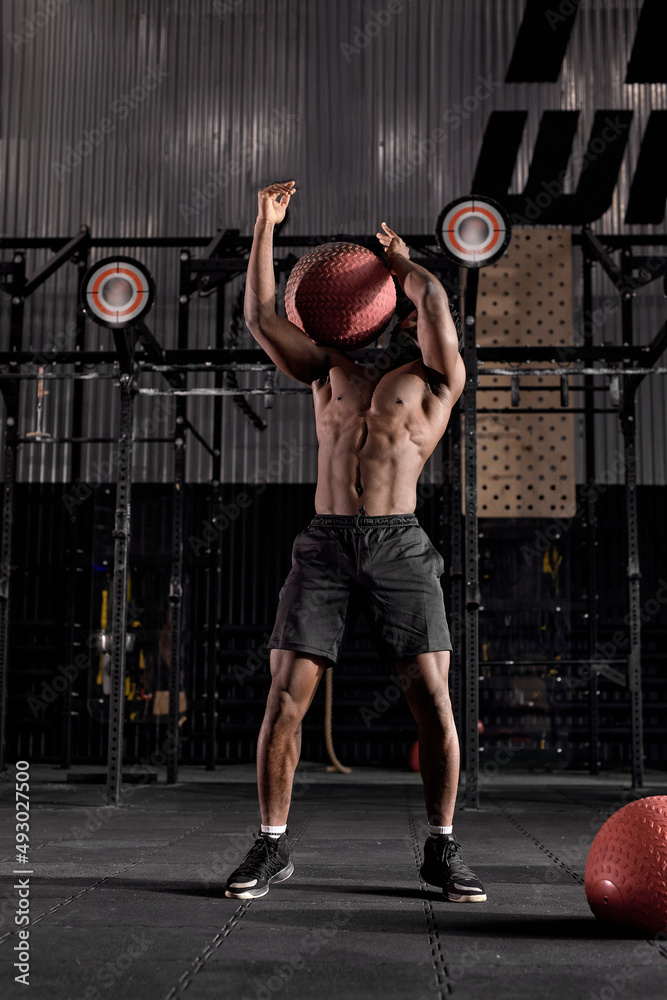 african athlete trains hard in gym, doing exercises with ball for ...