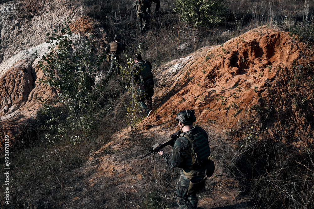 team of soldiers descend from mountain, leaving the hot spot during ...
