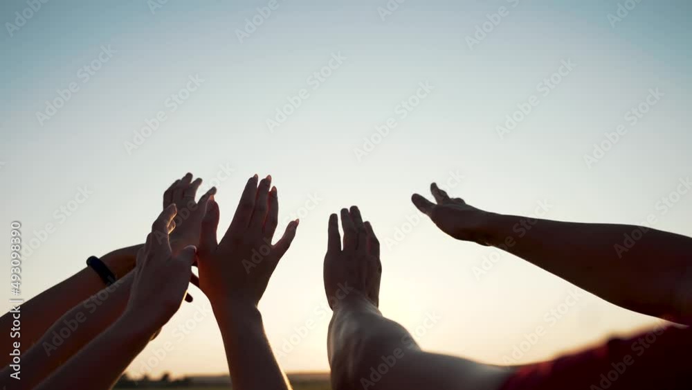 Happy family. Group of people stretch their hands to sun. Teamwork of ...