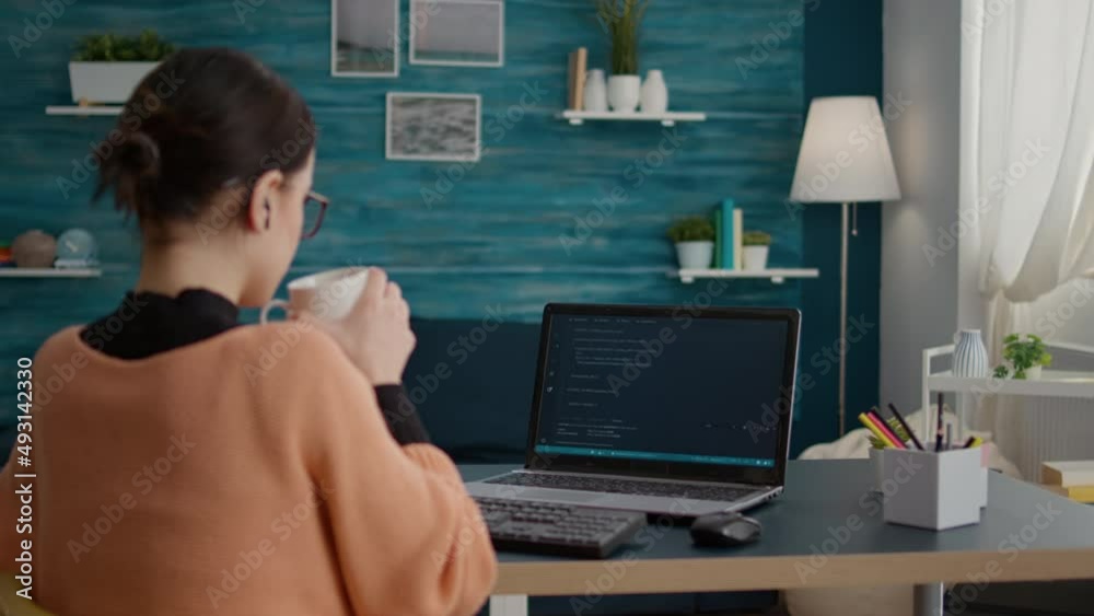 IT student using programming interface and binary code on laptop ...