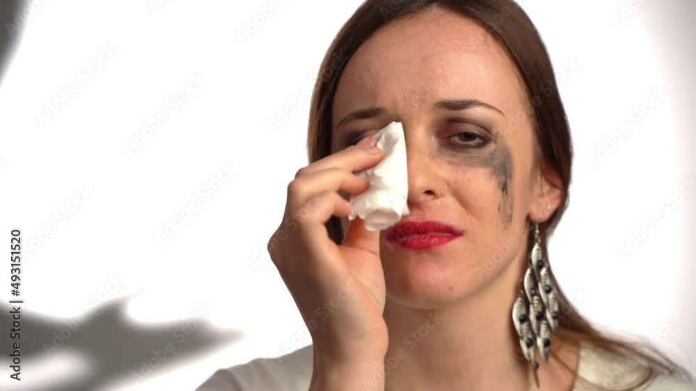 Afraid female victim wiping away tears from beaten face, terrified ...